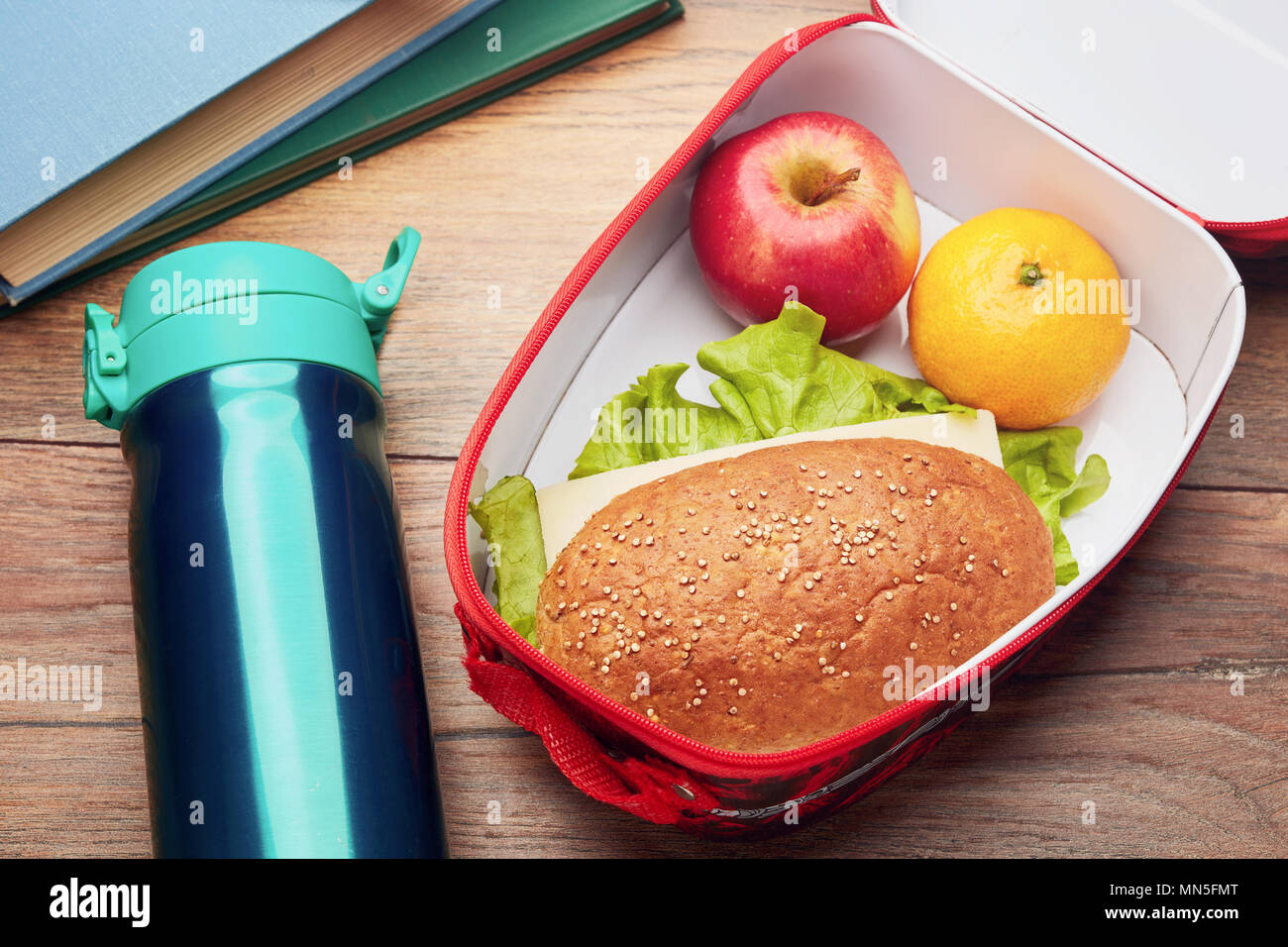 Healthy lunch box with whole wheat bread sandwich, fresh fruits, and ...