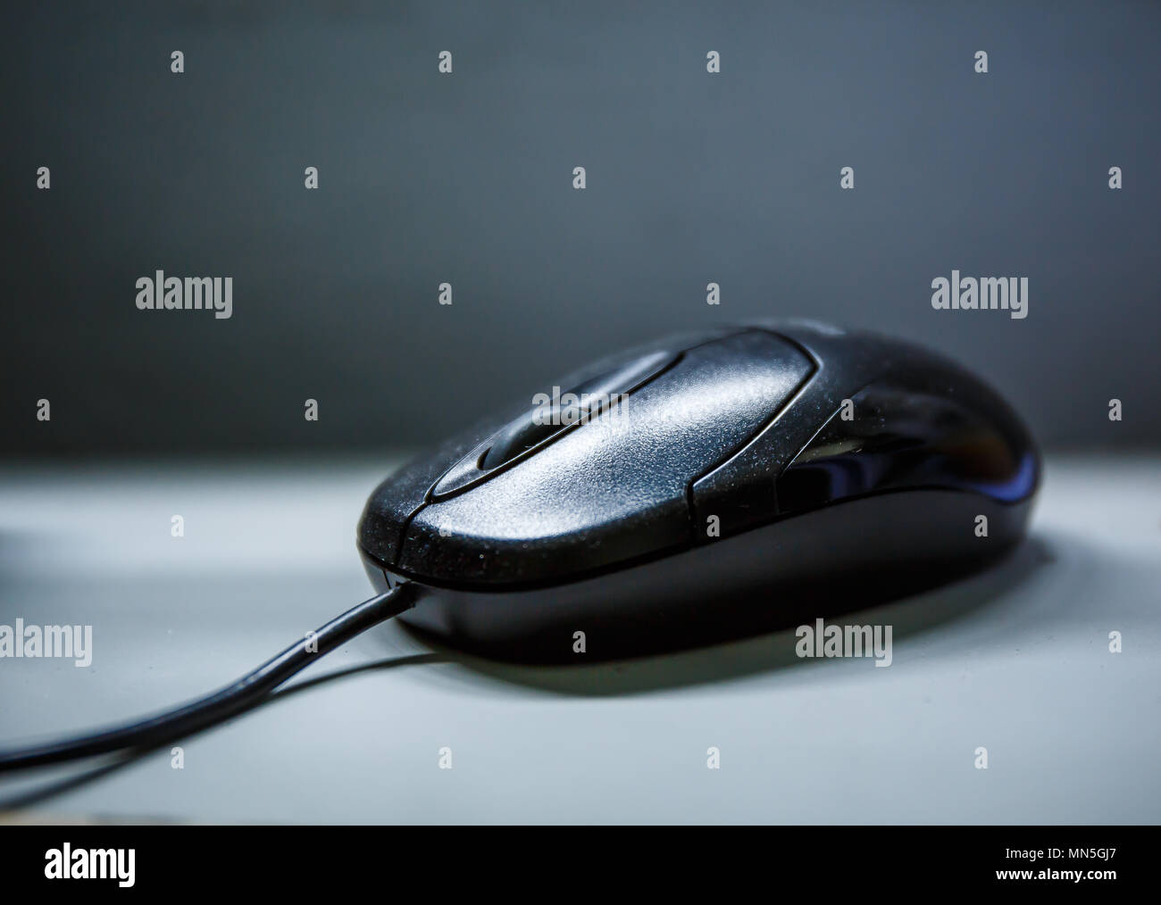 Black computer mouse on a black background Stock Photo - Alamy
