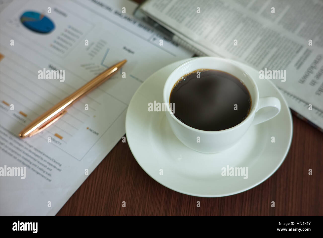 Coffee cup on working table in the morning Stock Photo - Alamy