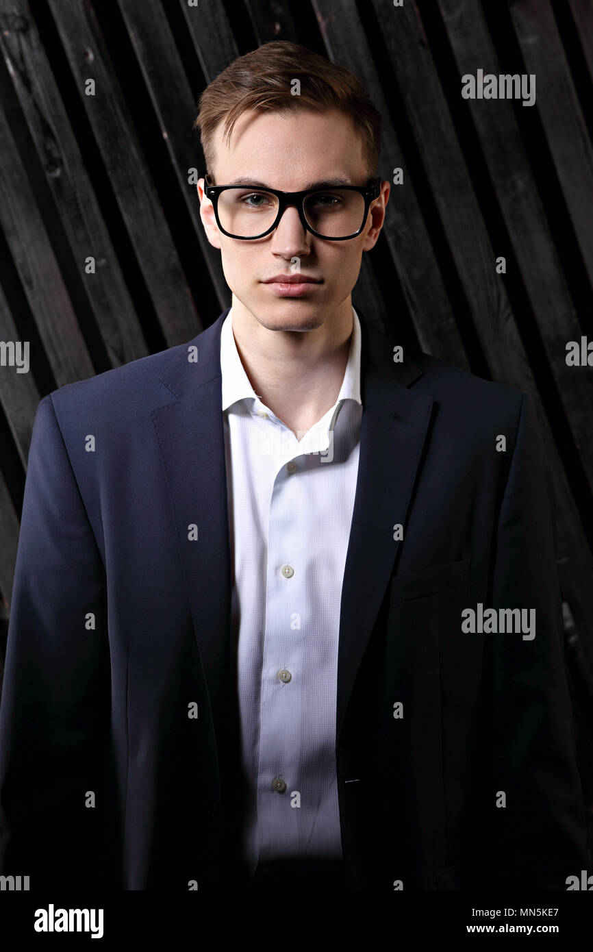 Serious successful business man looking in suit and trendy eyeglasses ...
