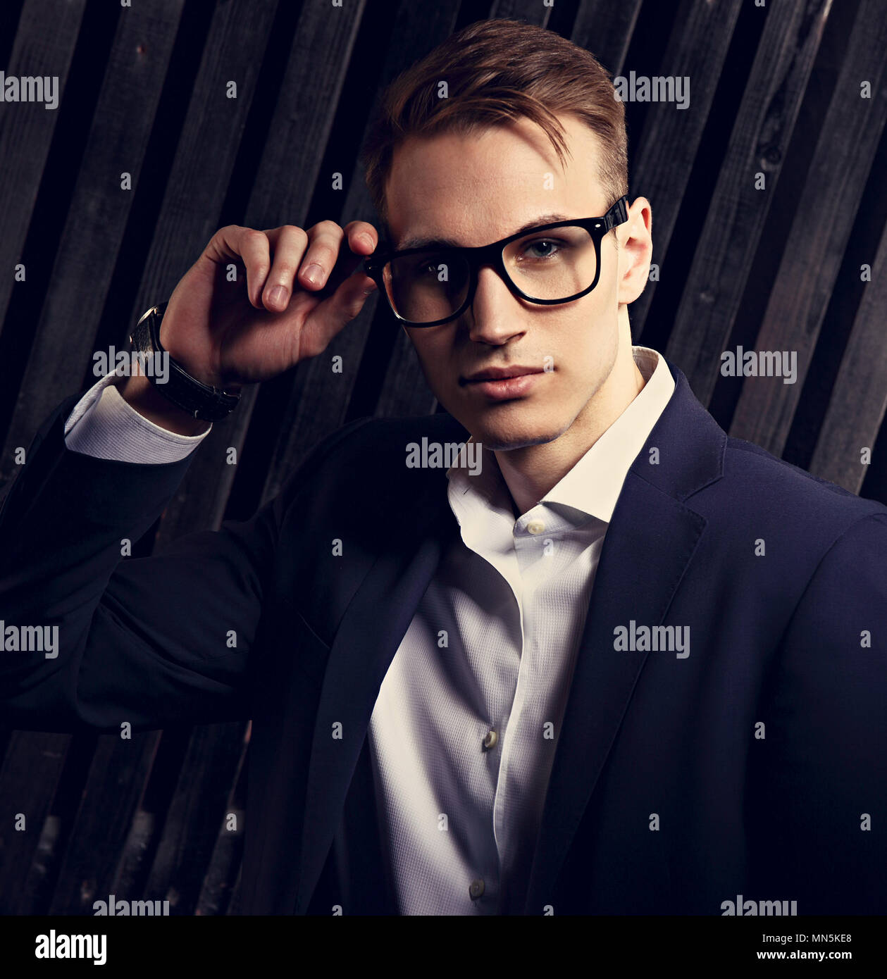 Serious successful business man looking in suit and trendy eyeglasses ...