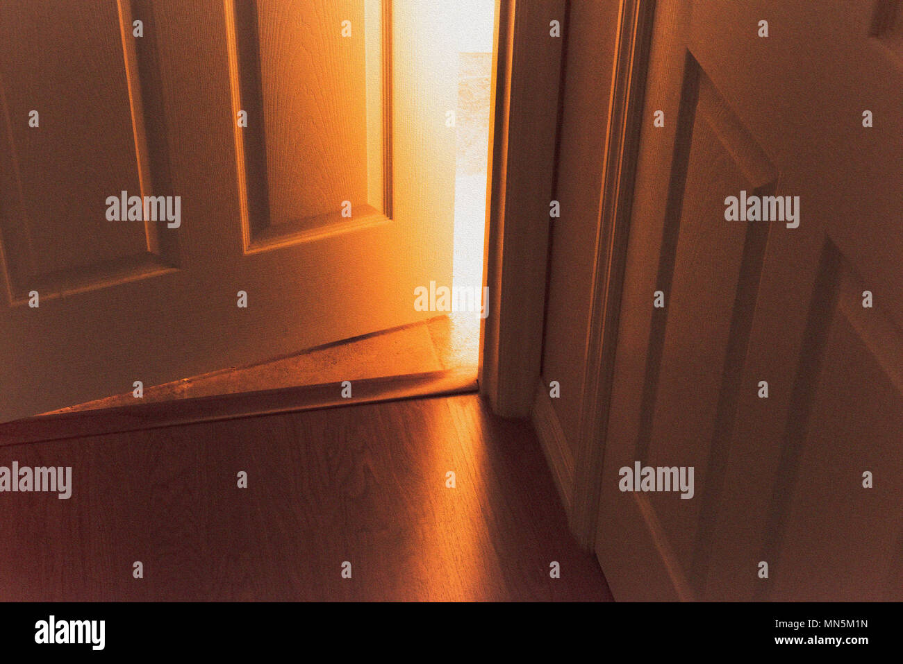 Cracked open door glowing hi-res stock photography and images - Alamy