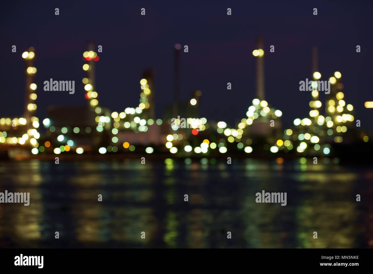 Abstract blur background of Oil refinery reflex on river at night Stock ...