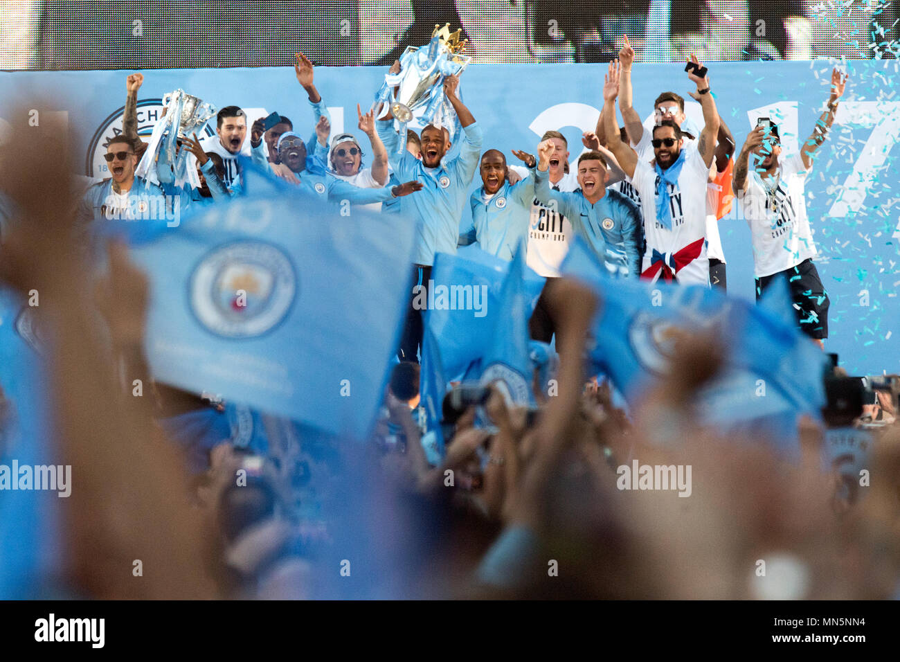 Manchester City Players Lift The Trophies On Stage During The Premier