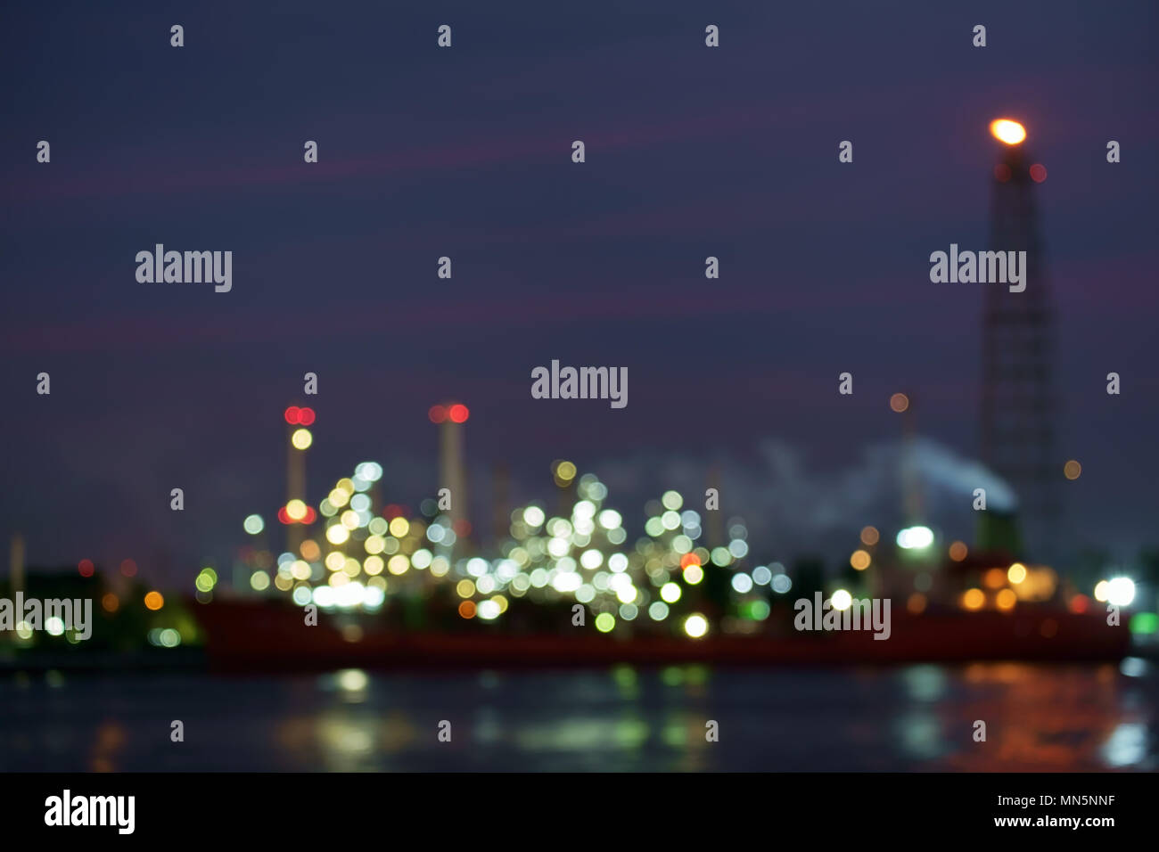 Abstract blur background of Oil refinery reflex on river at night Stock ...