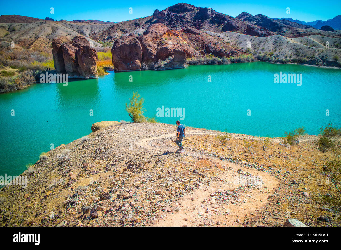 A man behind a wonderful creation of Balanced Rock Cove Stock Photo - Alamy