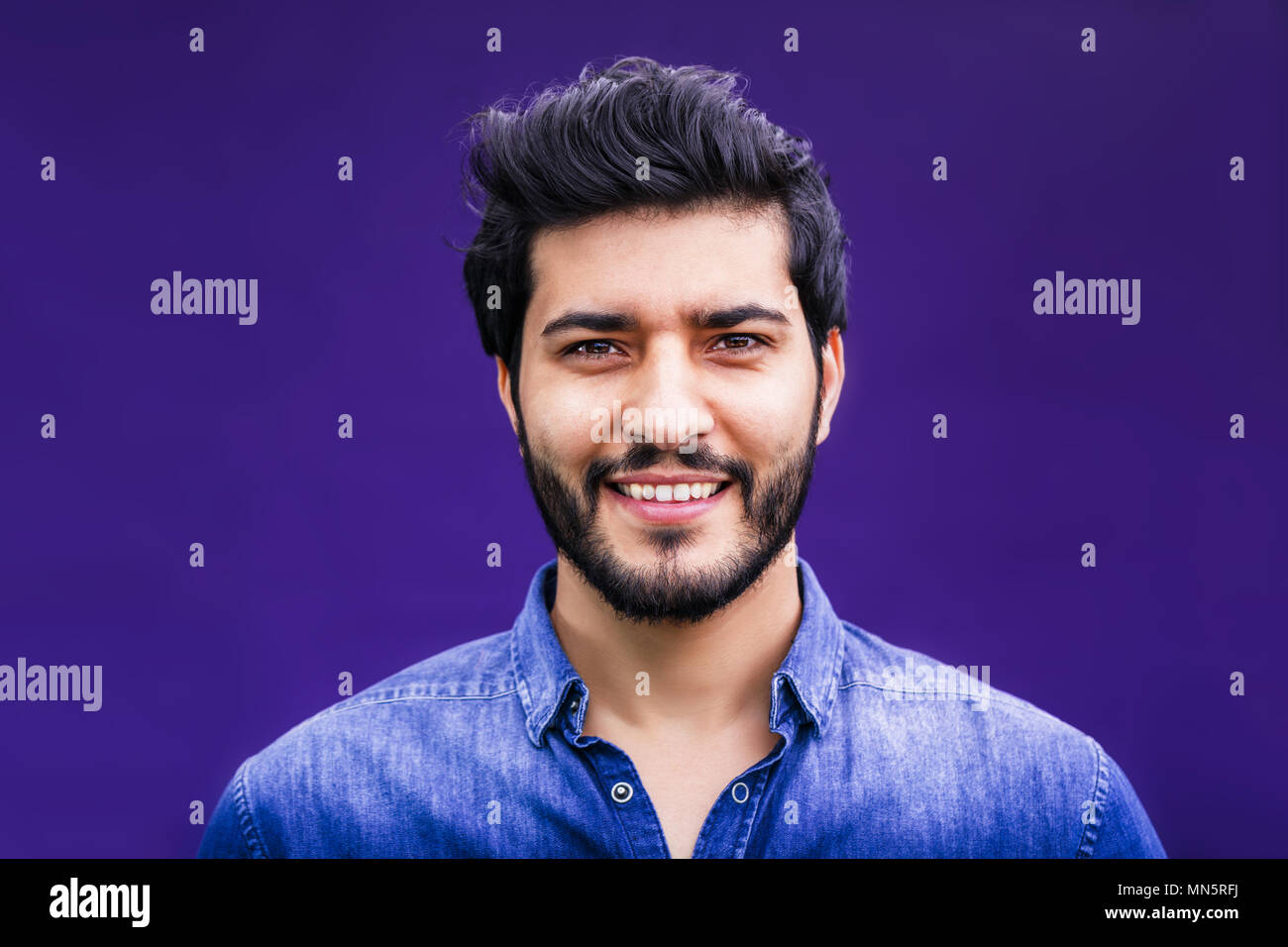 Portrait of eastern arabian man on purple background Stock Photo - Alamy