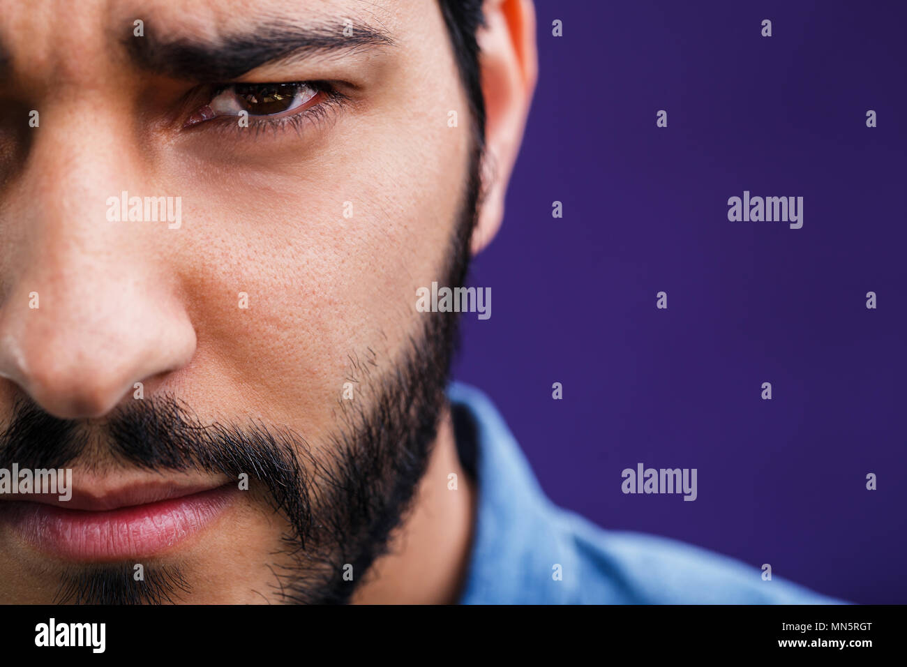 Portrait of eastern arabian man on purple background Stock Photo - Alamy