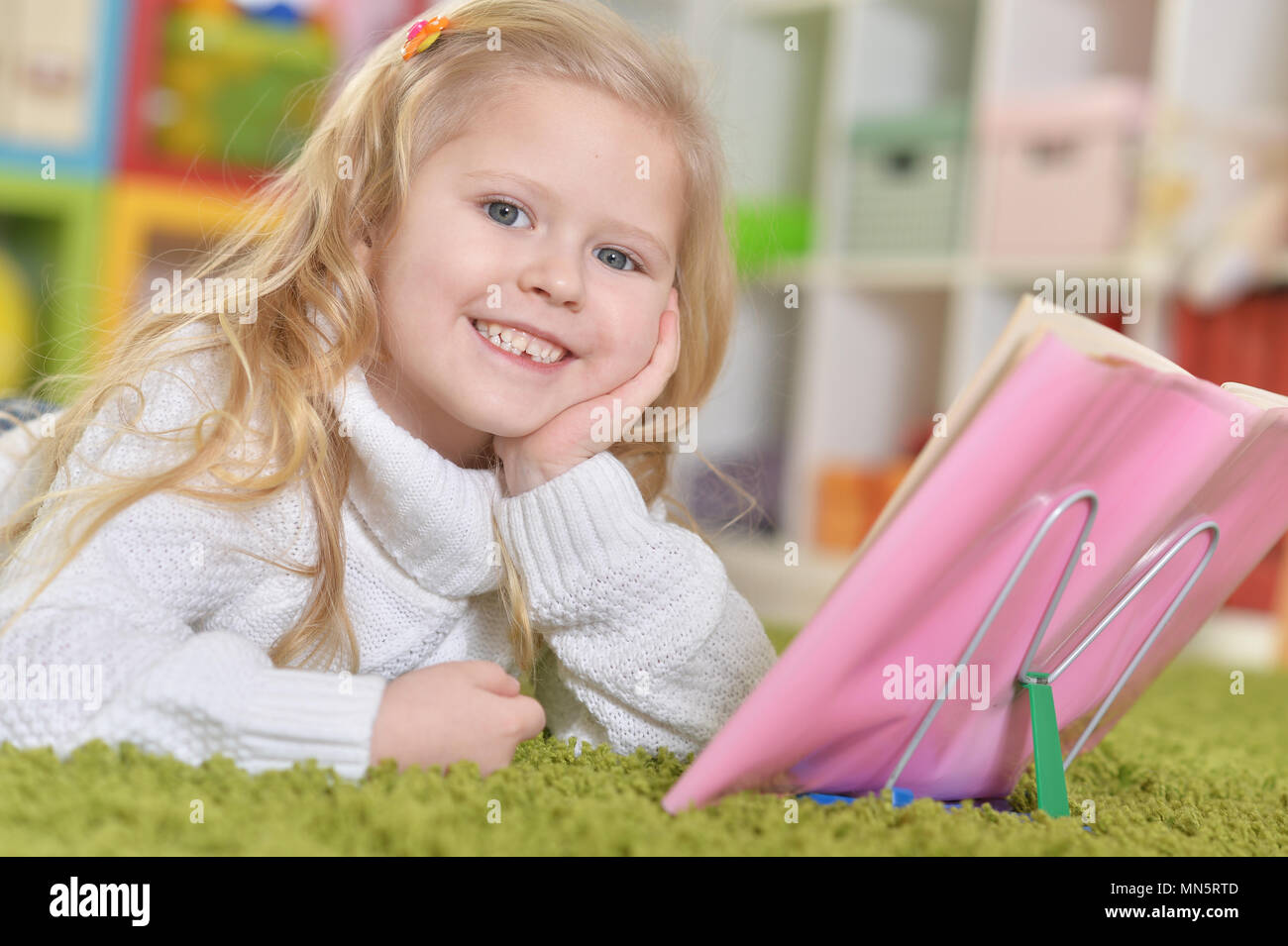 Cute little girl reading book Stock Photo - Alamy