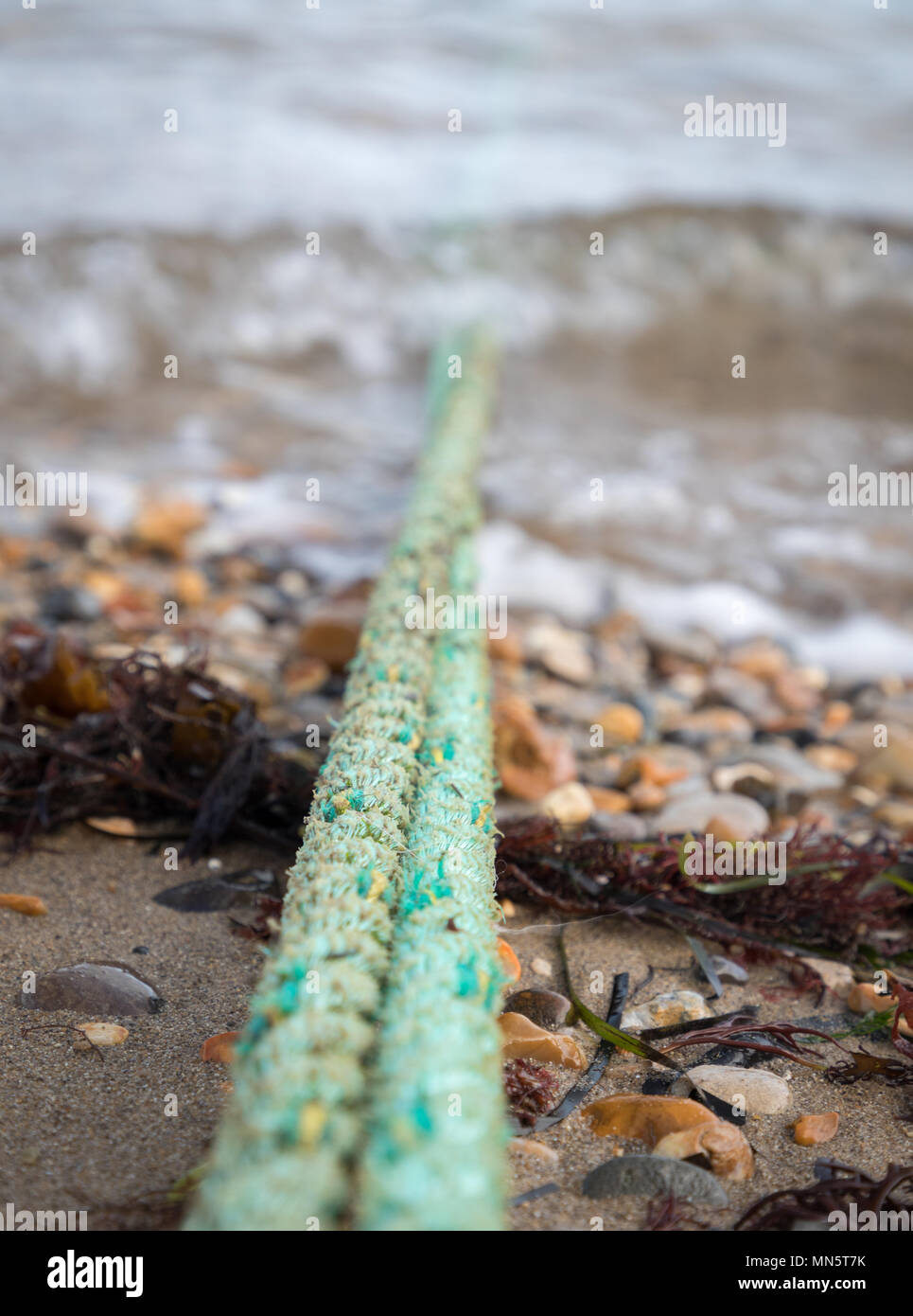 ropes leading out to sea on pebble beach Stock Photo - Alamy
