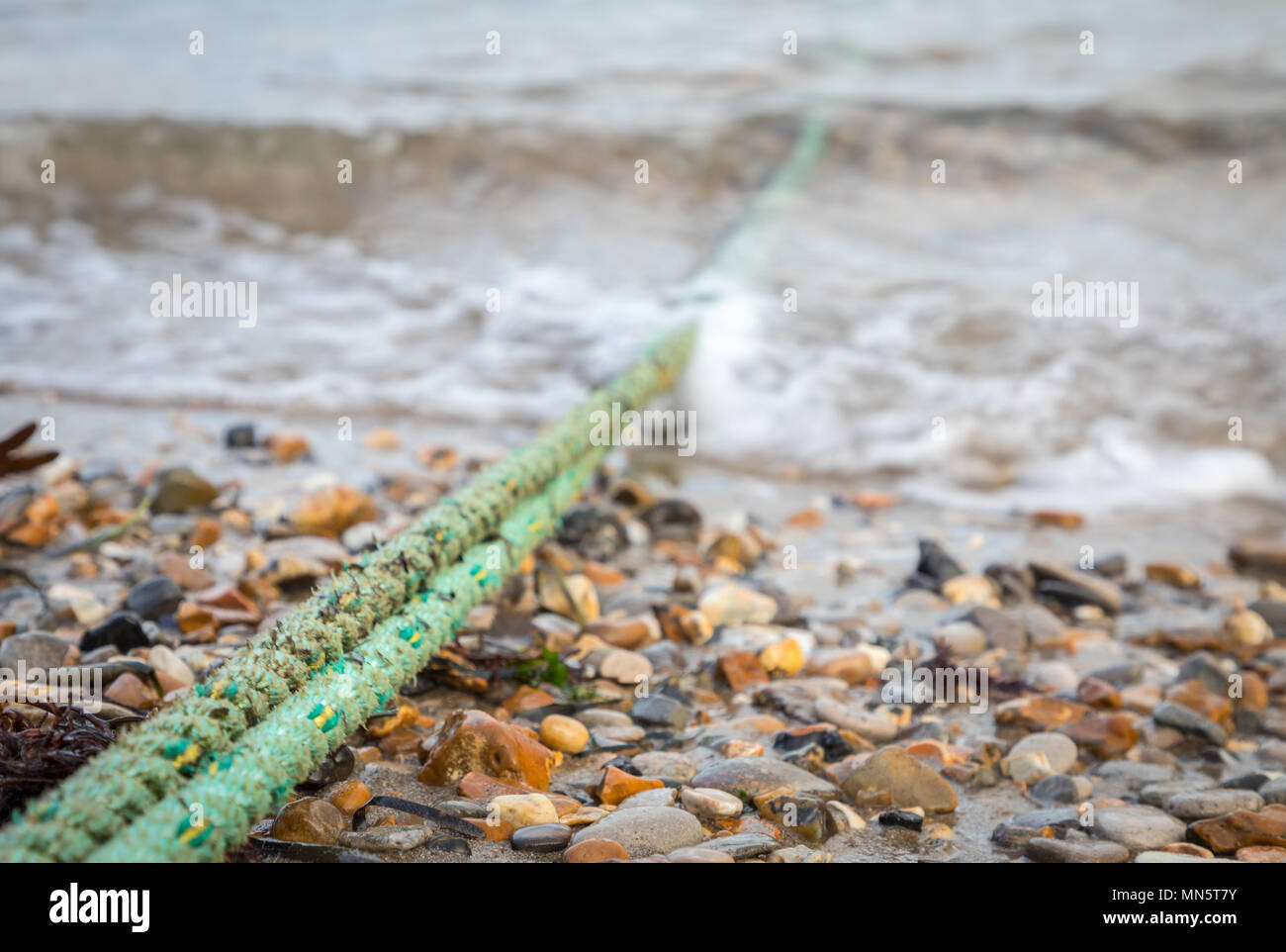 ropes leading out to sea on pebble beach Stock Photo - Alamy
