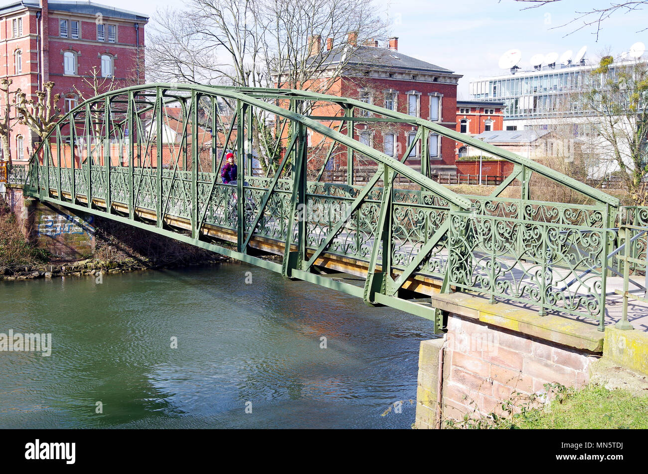 Elegant green-painted iron footbridge built in 1889 across the river ...