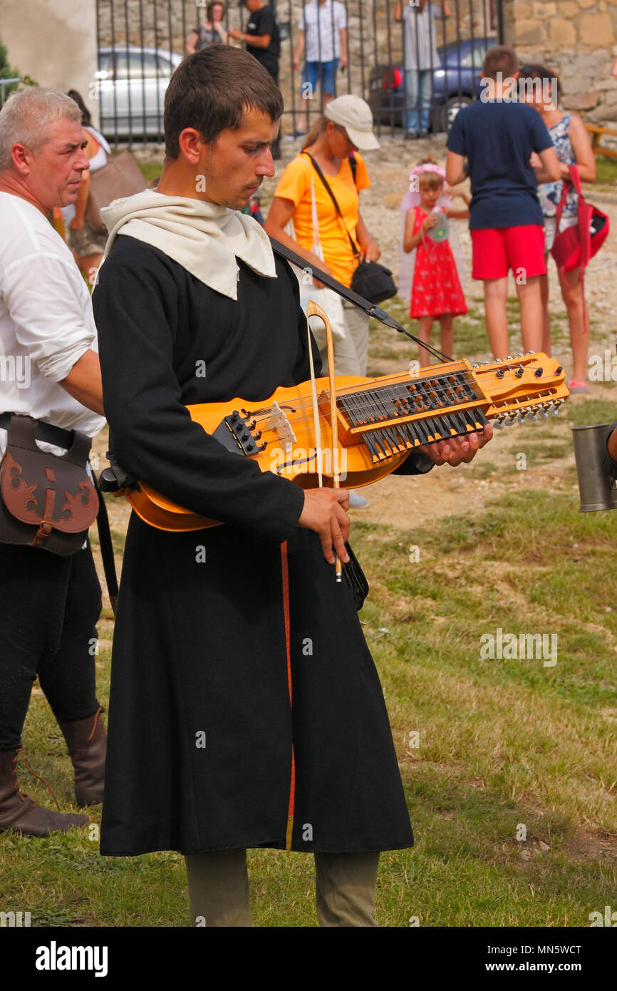 Musician in ancient clothings with instrument. "Knight's Tournament ...