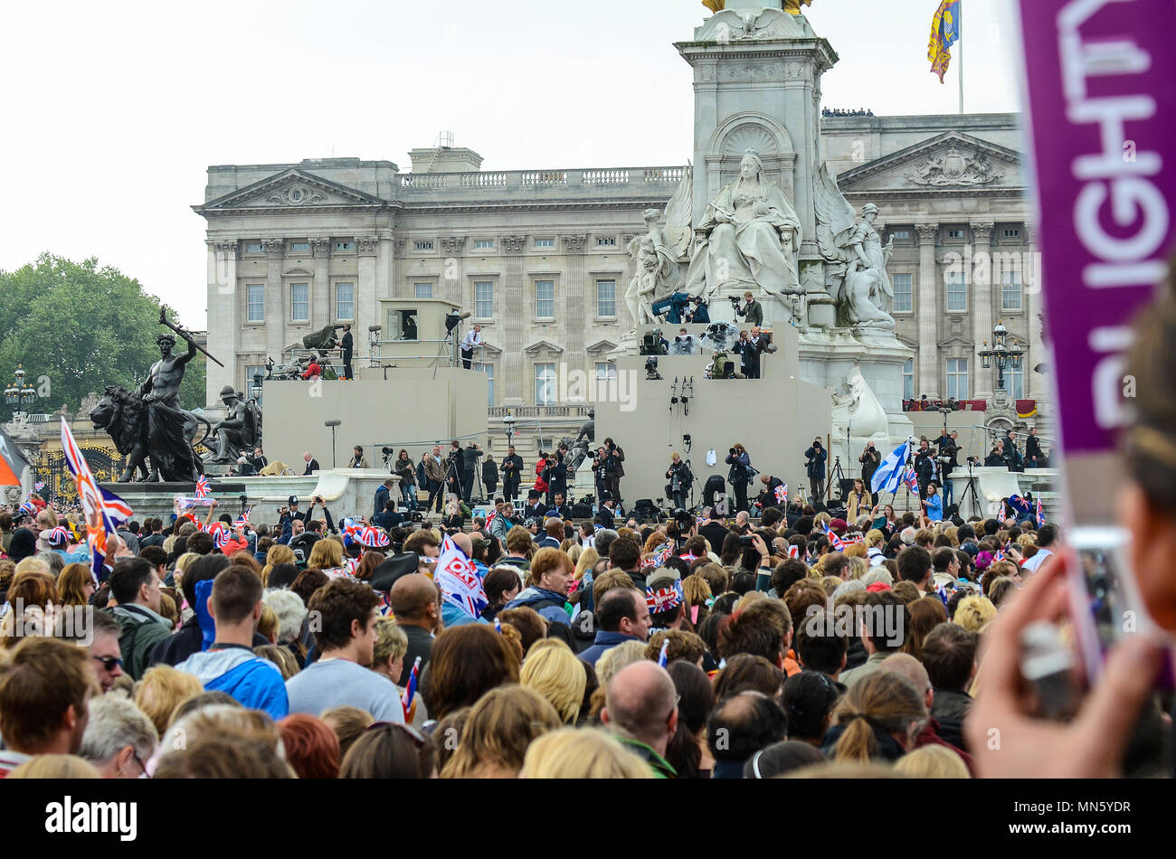 Royal wedding. Huge crowds try to squeeze into the space at Buckingham Palace around Victoria ...