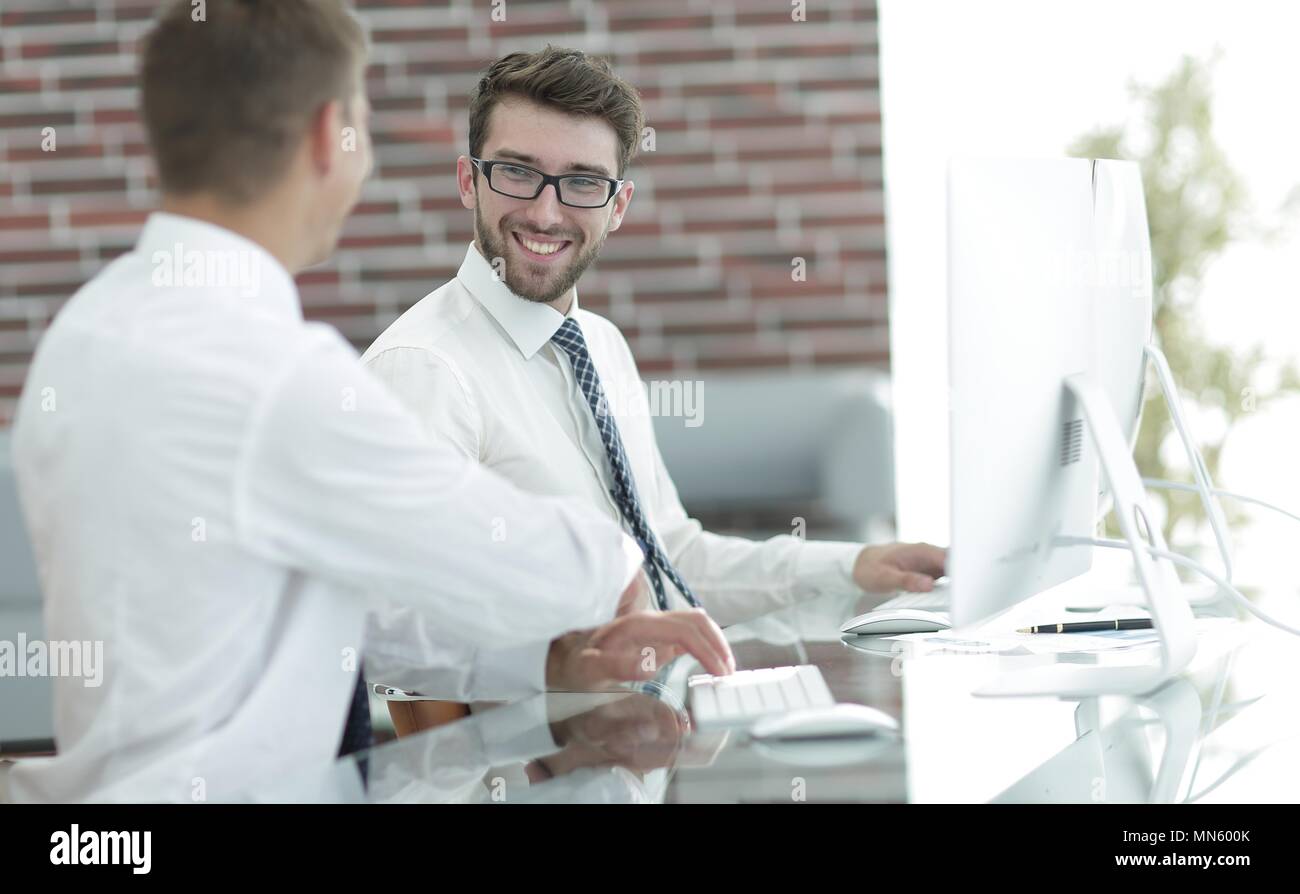 handshake of the employees at the Desk Stock Photo - Alamy