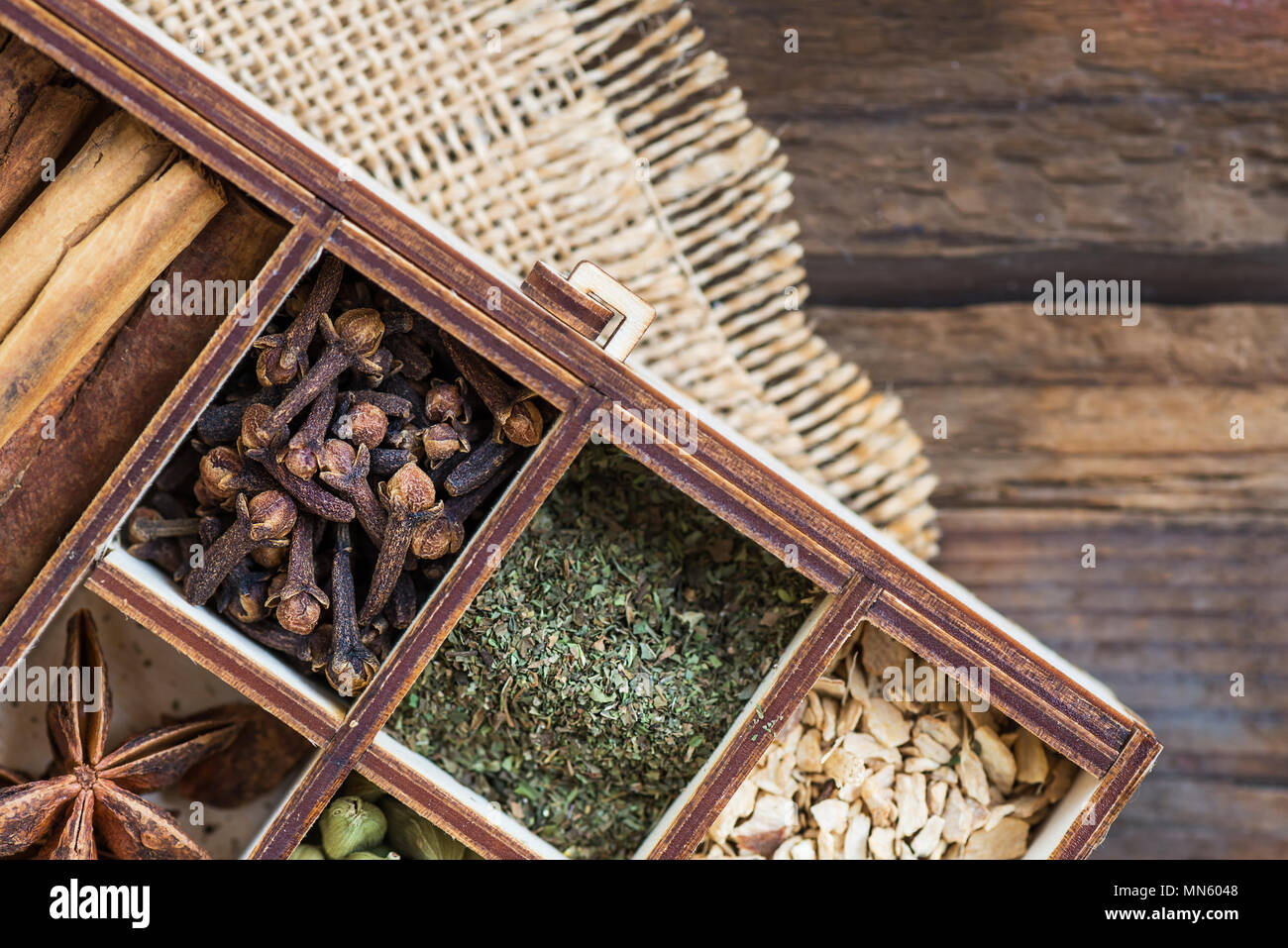 Box with variety of dried spices, such as ginger, mint, clove, chili ...