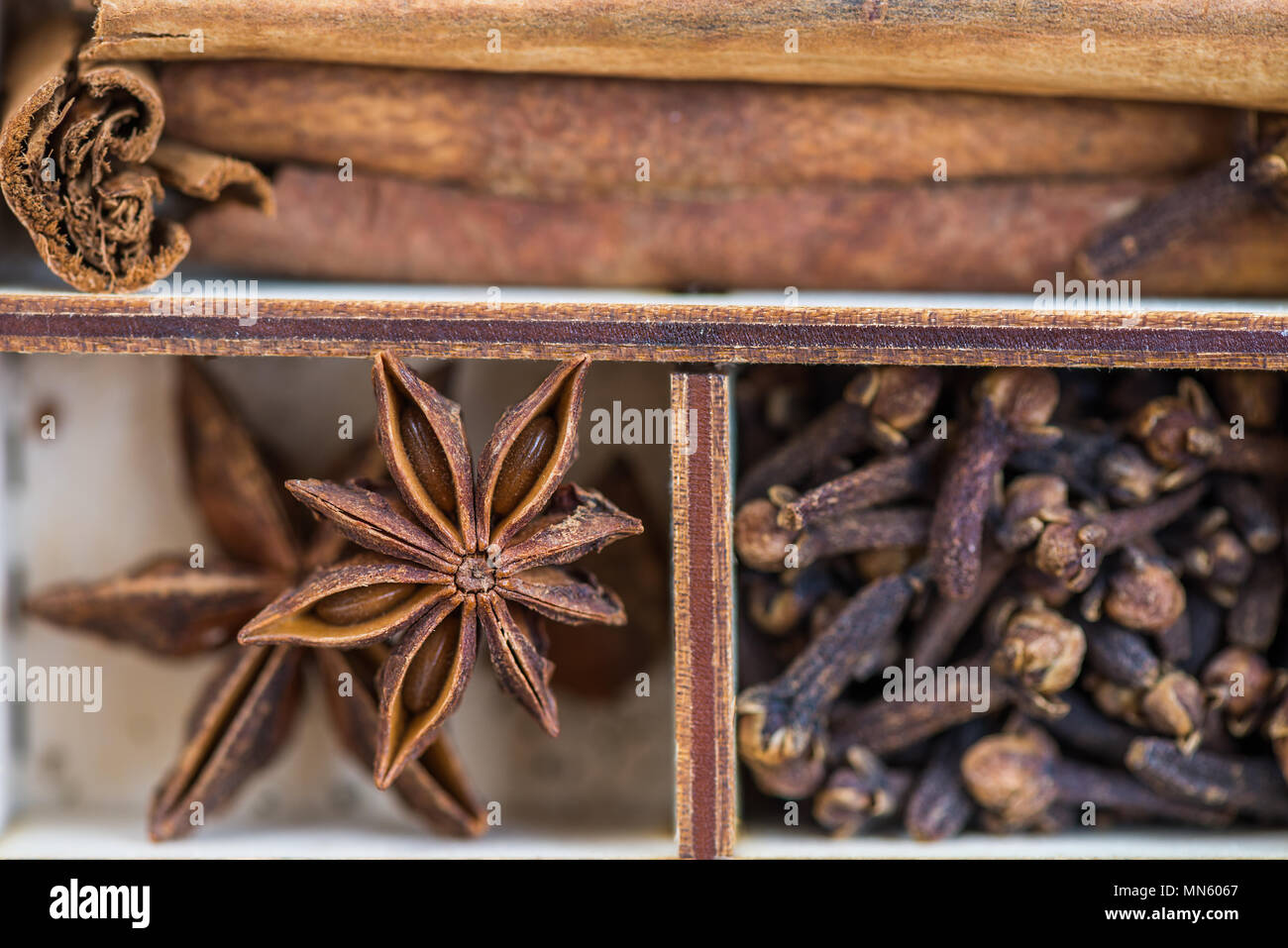 Box with variety of dried spices, such as ginger, mint, clove, chili ...
