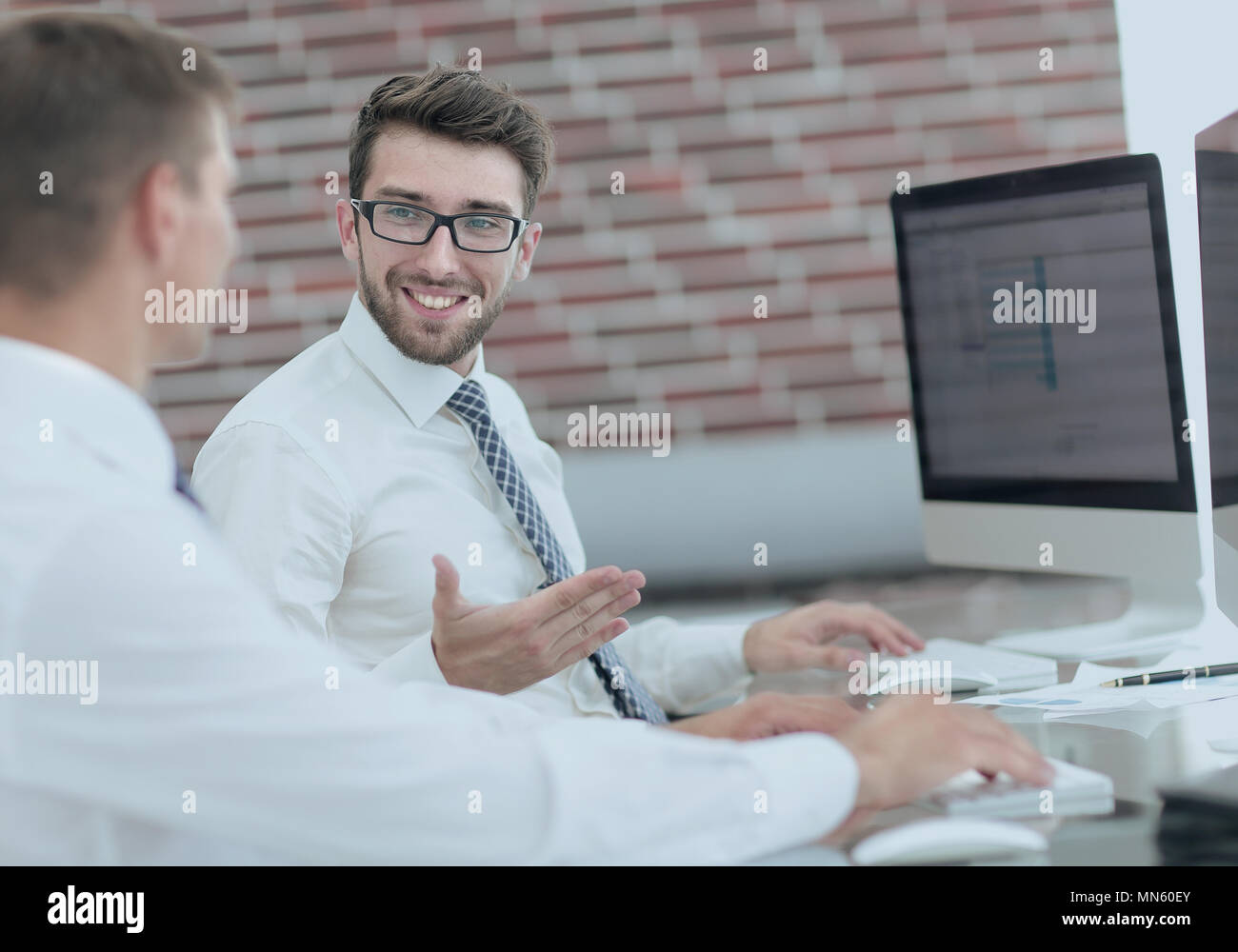 experienced employees to discuss working document Stock Photo - Alamy