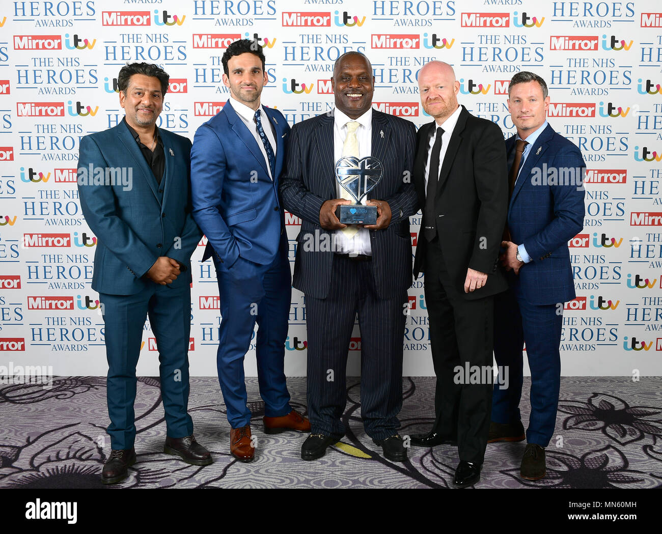 Errol McKellar (centre) wins the Hero Volunteer Award at the NHS Heroes ...