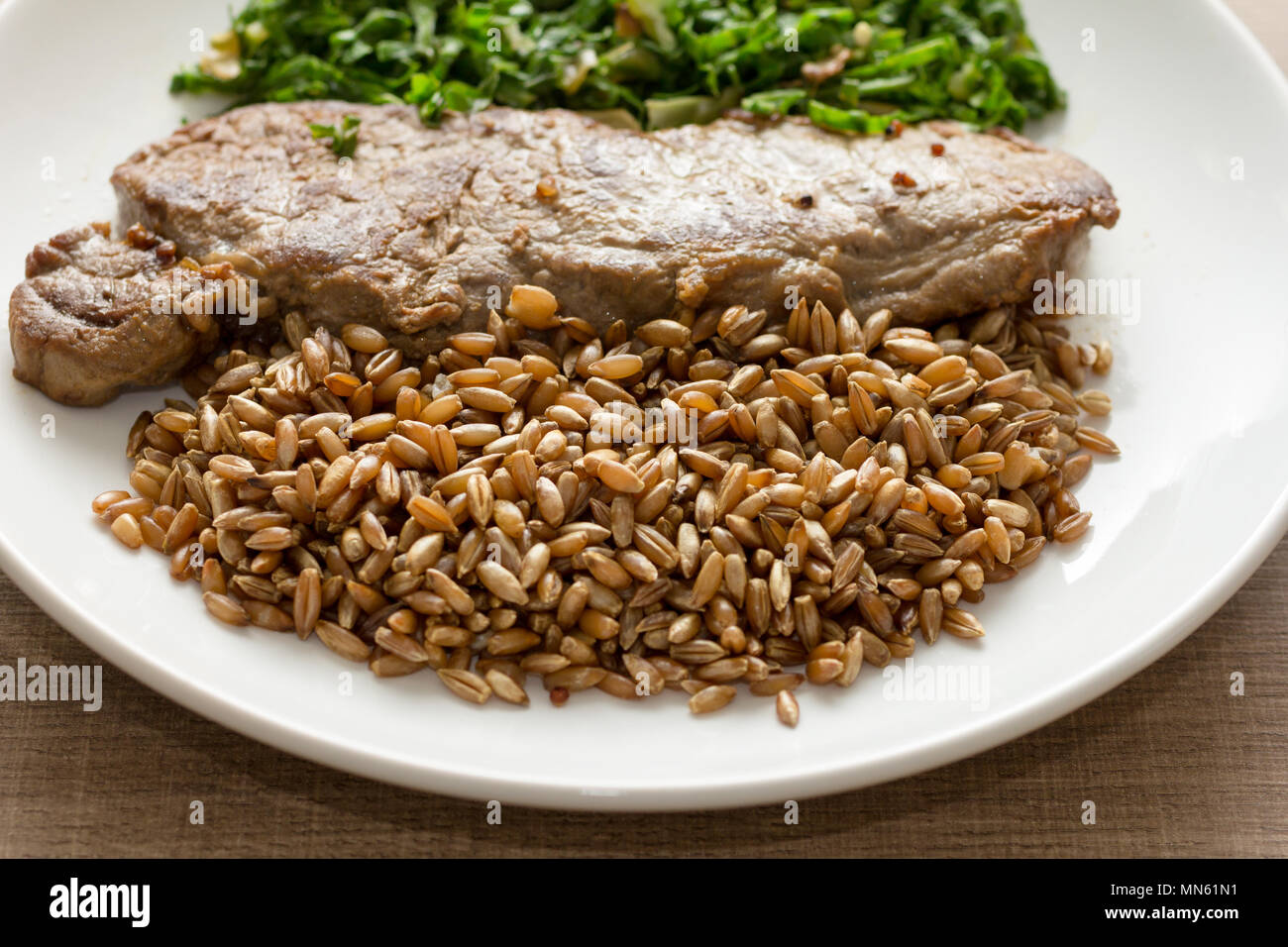 Meal with rye, steak and cabbage on a white plate. Healthy eating ...