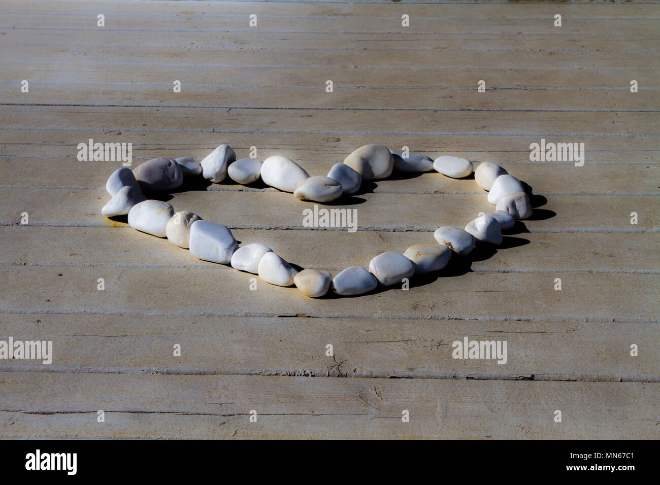 Stone heart love messages by the beach Stock Photo - Alamy