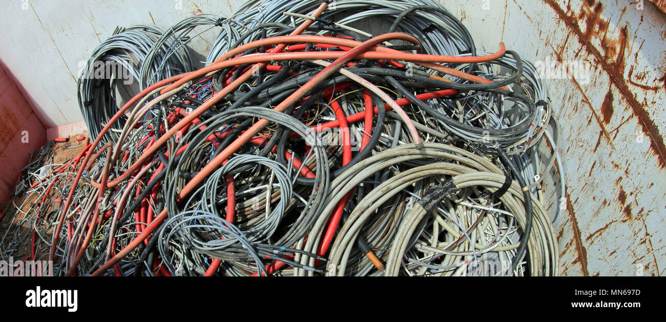 pile of obsolete electric cables into a big container Stock Photo - Alamy