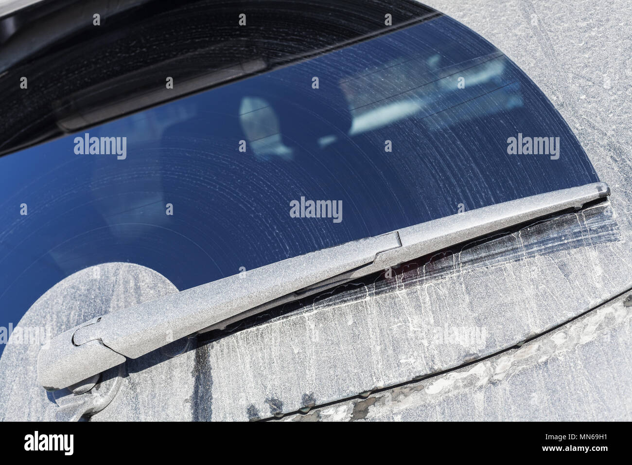 Close-up photo of car wiper on dirty rear window of modern SUV car ...