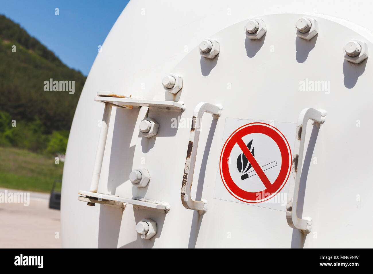 White tank with liquefied petroleum gas and flammable warning sign ...