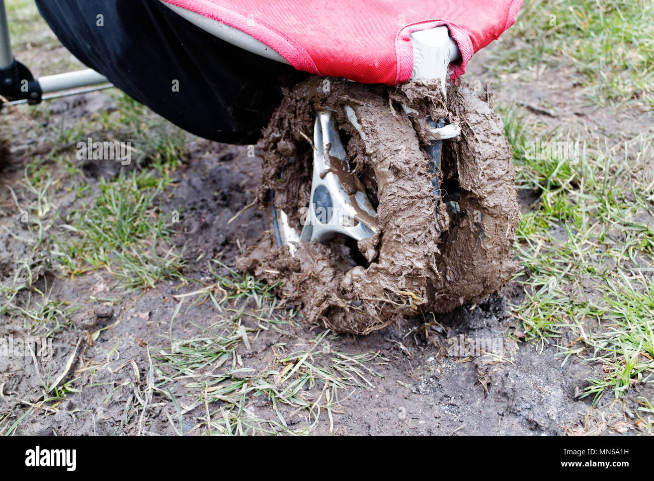 Pushchair wheels caked in mud on a muddy walk in the Peak District in ...
