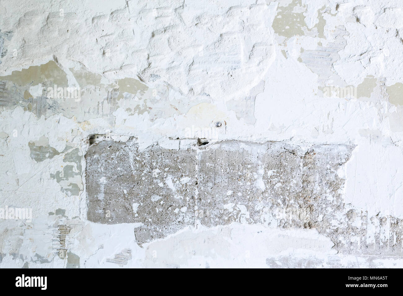 Textured ragged white wall plaster, after taking out tile. The wall ...