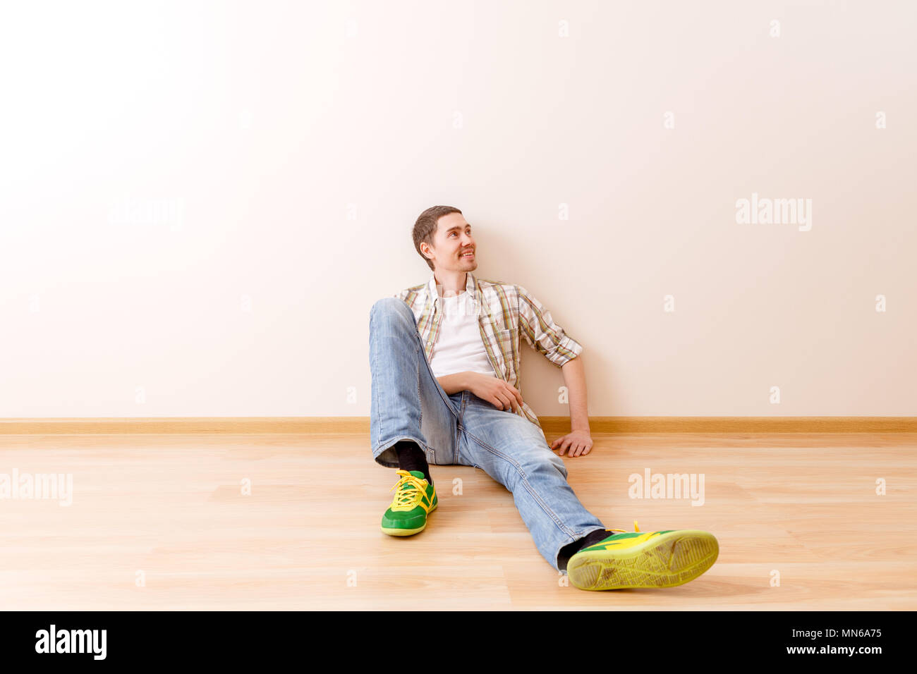 Photo of man sitting on floor Stock Photo - Alamy