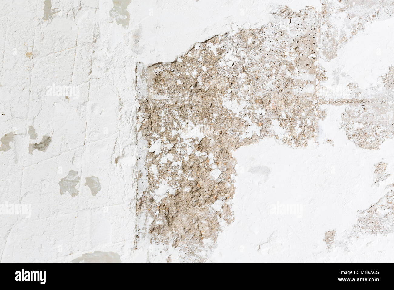 Textured ragged white wall plaster, after taking out tile. The wall ...