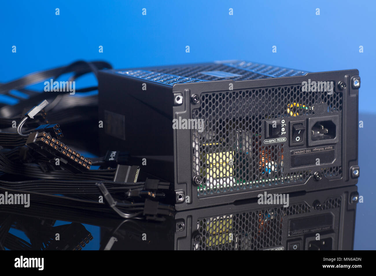 Computer Power Supply Unit with cable on blue background Stock Photo ...