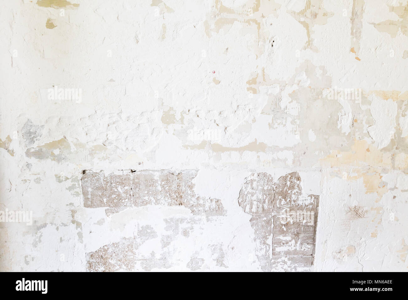 Textured ragged white wall plaster, after taking out tile. The wall ...