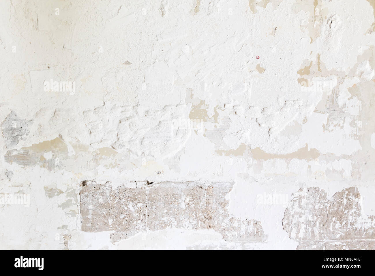 Textured ragged white wall plaster, after taking out tile. The wall ...