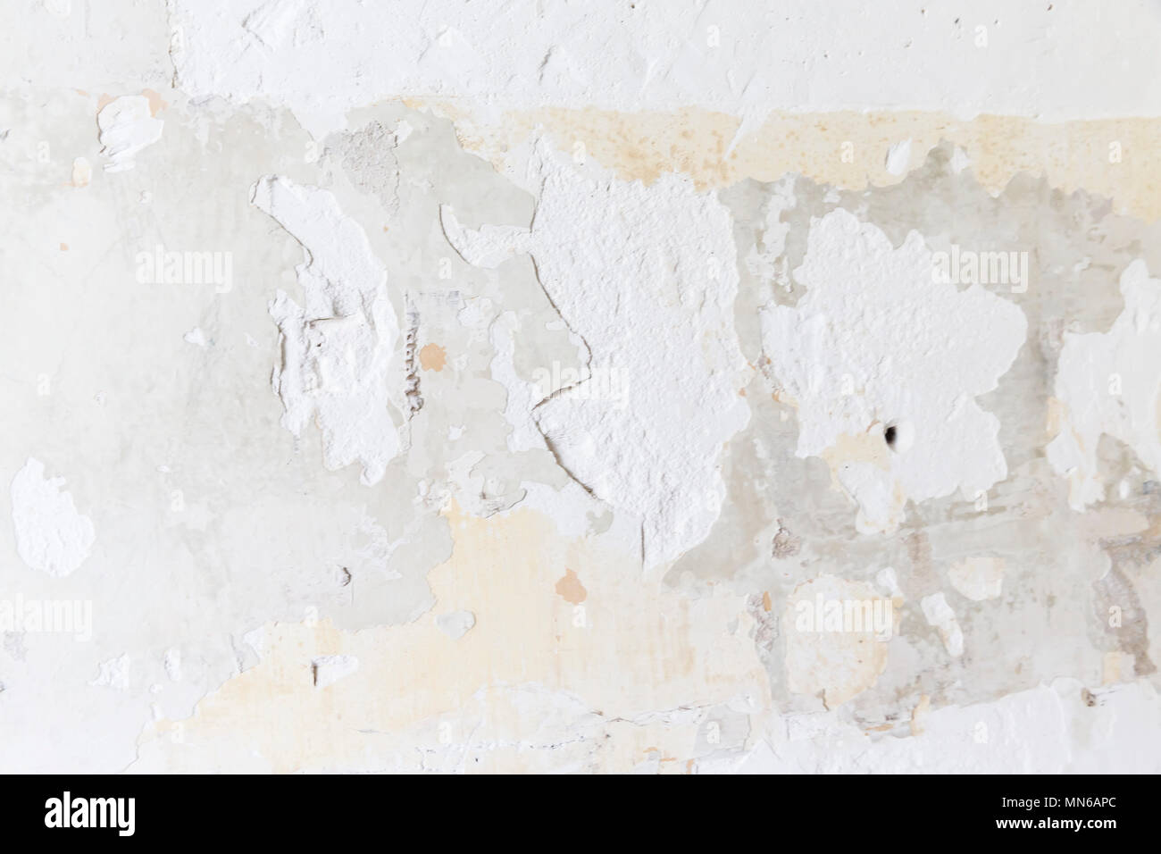 Textured ragged white wall plaster, after taking out tile. The wall ...