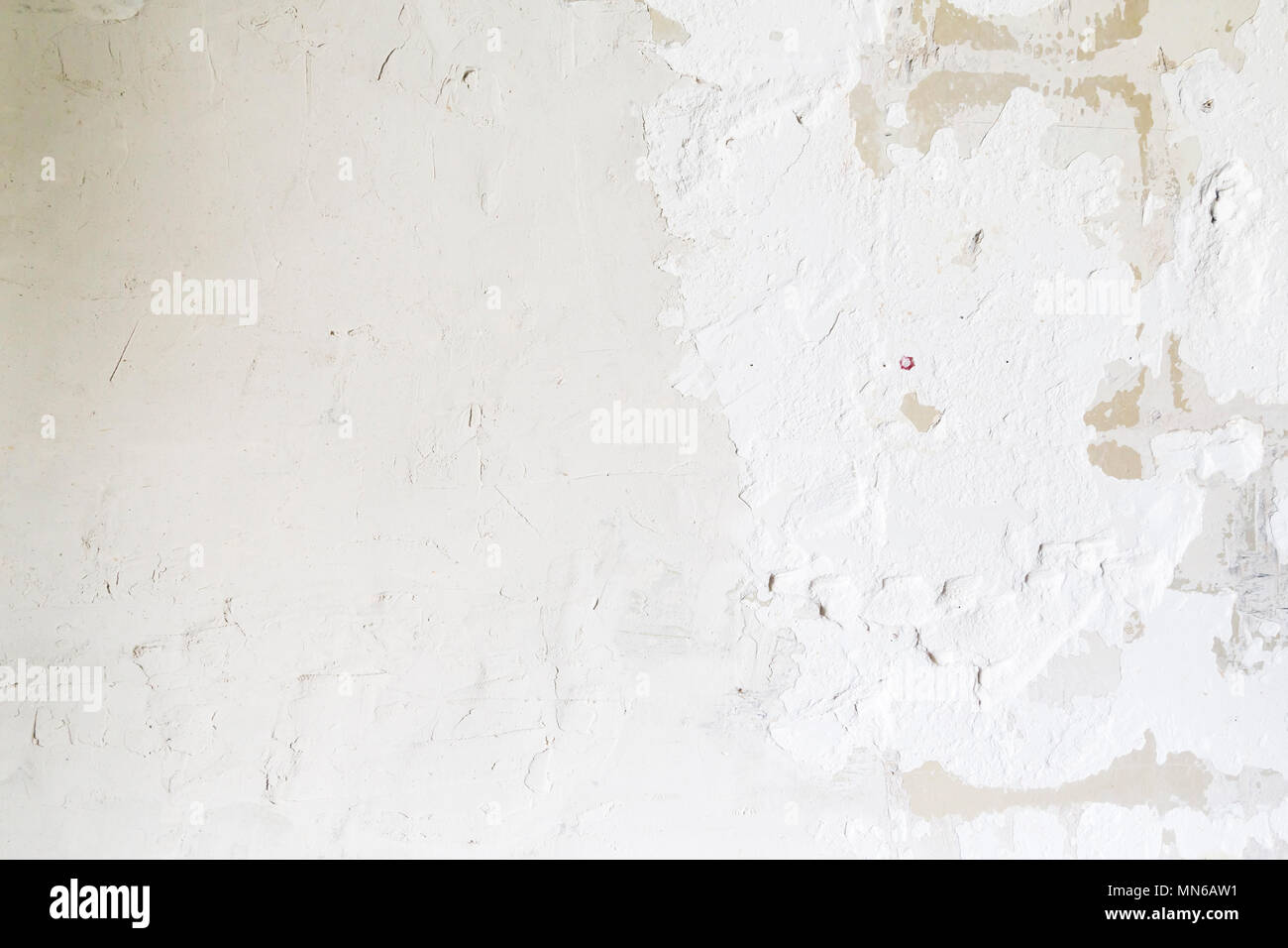 Textured ragged white wall plaster, after taking out tile. The wall ...