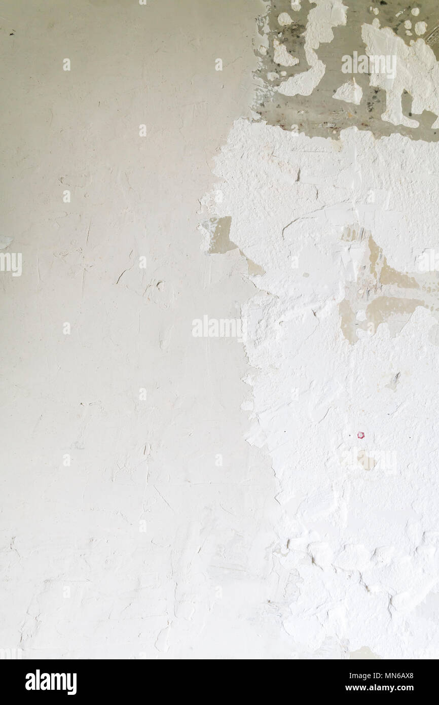 Textured ragged white wall plaster, after taking out tile. The wall ...