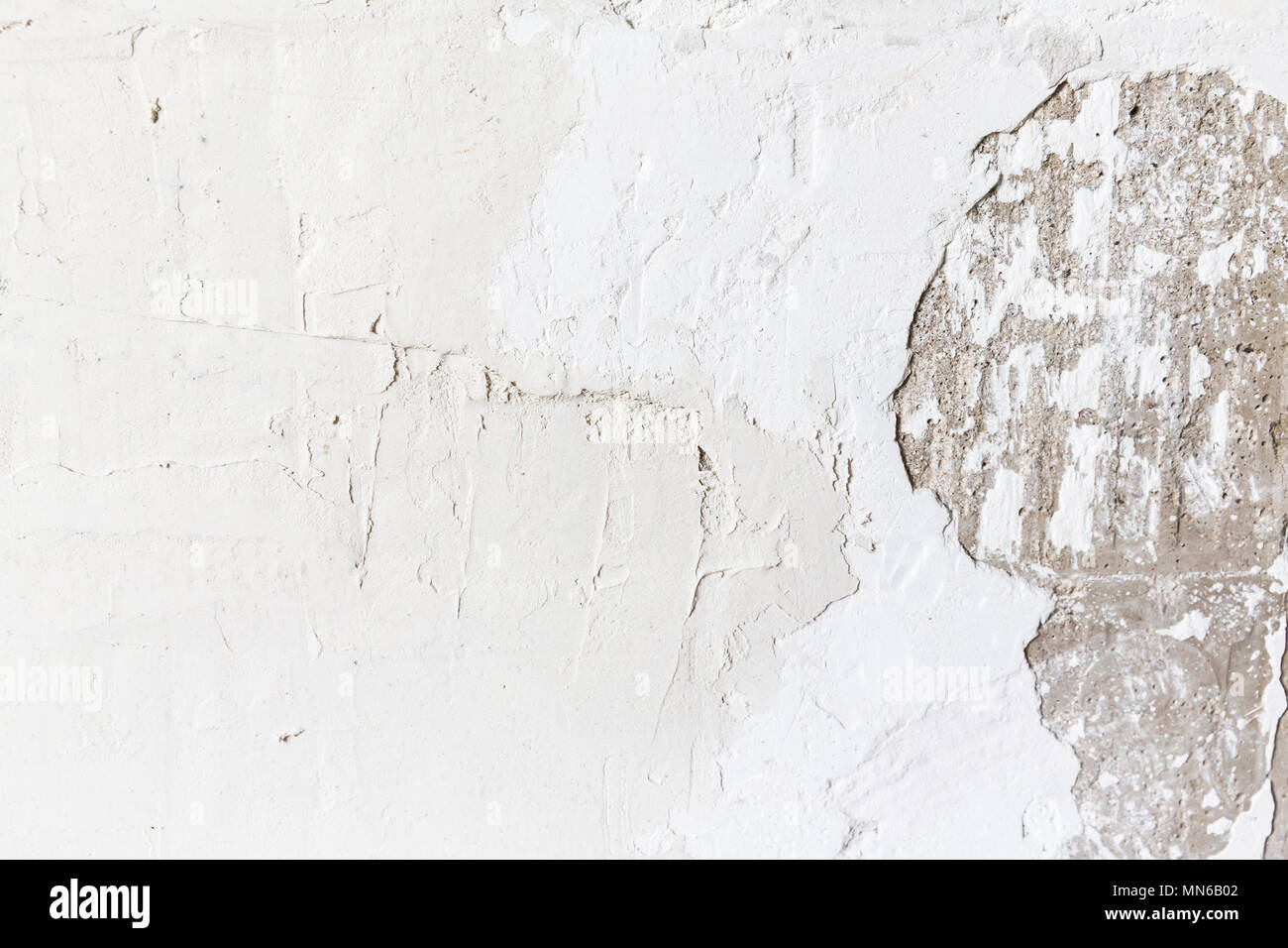 Textured ragged white wall plaster, after taking out tile. The wall ...