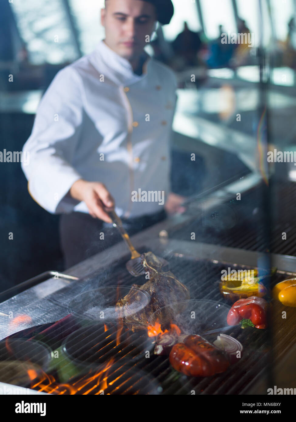 Master chef cooking delicious grilled meat steak with vegetables on a ...