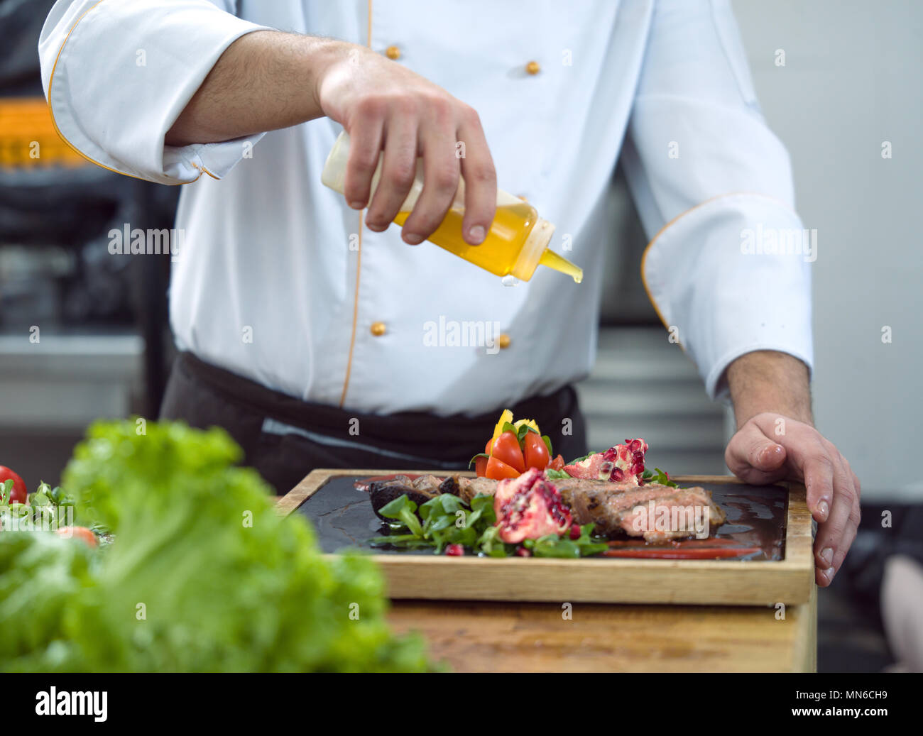 Chef finishing steak meat plate with Finally dish dressing and almost ...