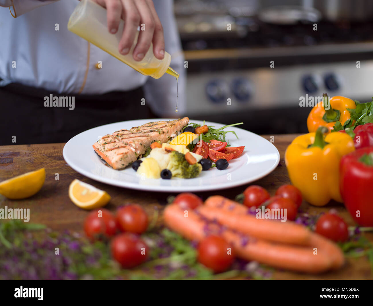 Chef finishing steak meat plate with Finally dish dressing and almost ...