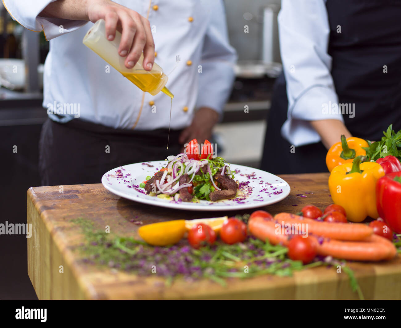 Chef finishing steak meat plate with Finally dish dressing and almost ...