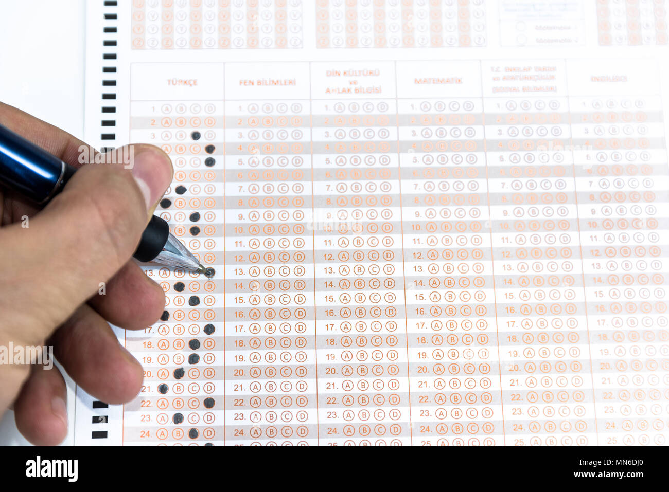 Man hand marks ,fill out answer with pencil on Test score sheet with ...