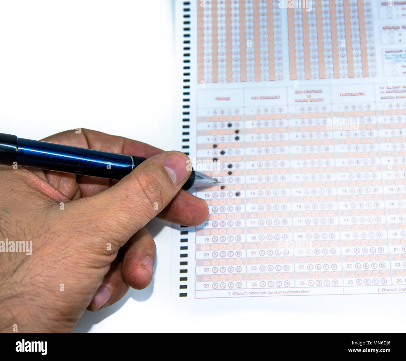 Man hand marks ,fill out answer with pencil on Test score sheet with ...