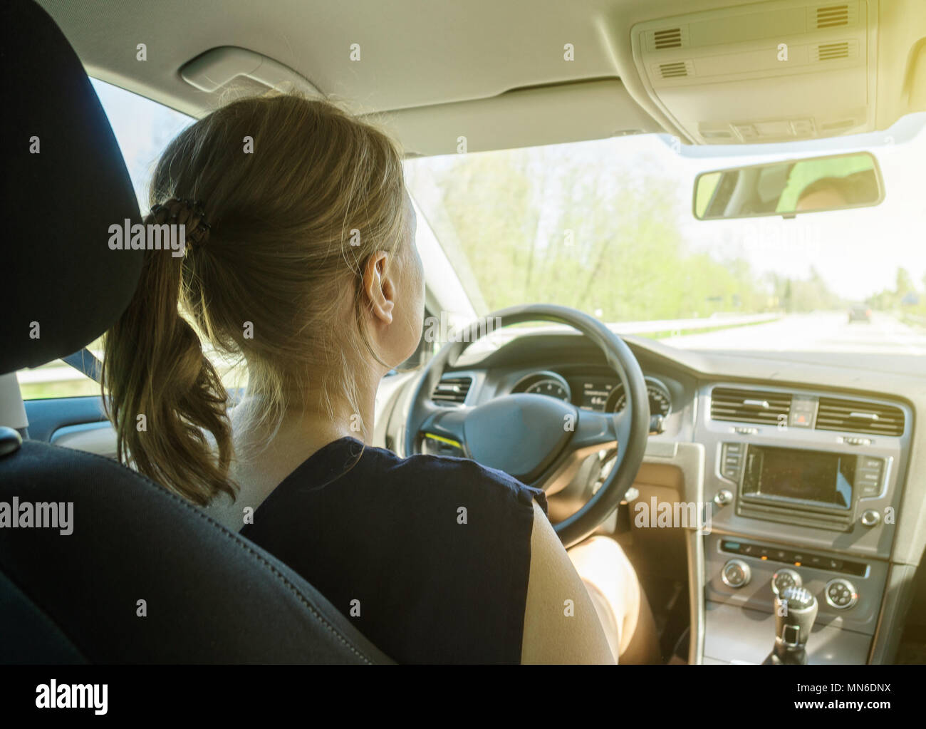 Woman is driving a car. Inside view Stock Photo - Alamy