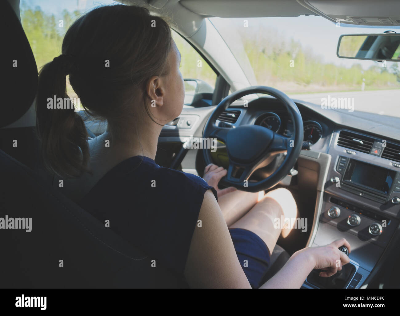 Woman is driving a car. Inside view Stock Photo - Alamy