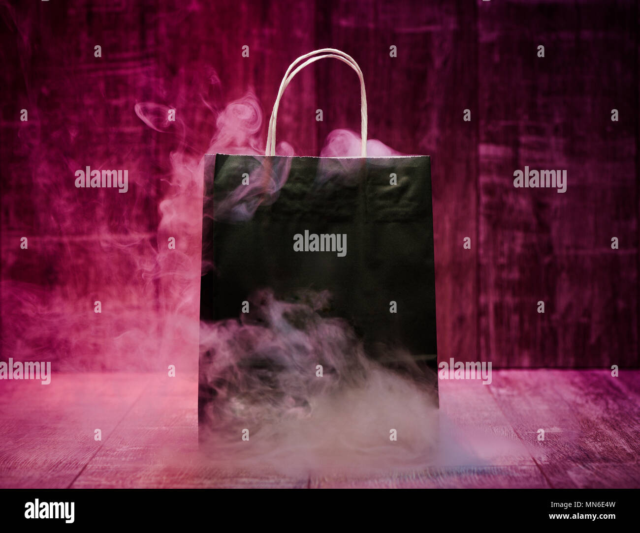 paper bag with smoke on wooden vintage background Stock Photo - Alamy