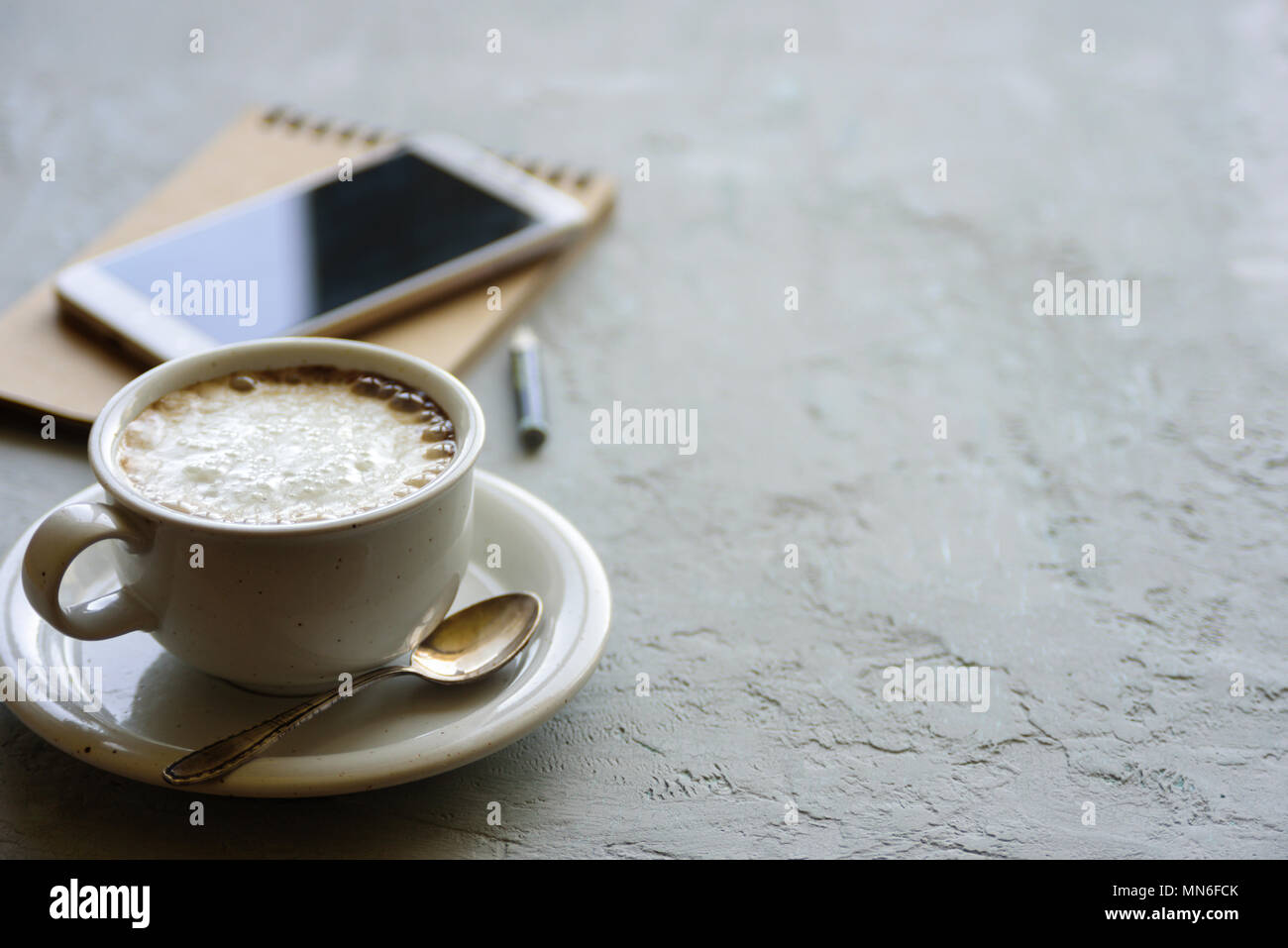 Cup of coffee on desk or workspace. Notebook, planner and phone Stock ...