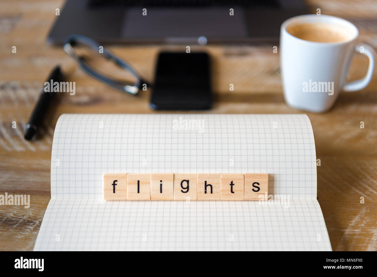 Closeup on notebook over wood table background, focus on wooden blocks ...